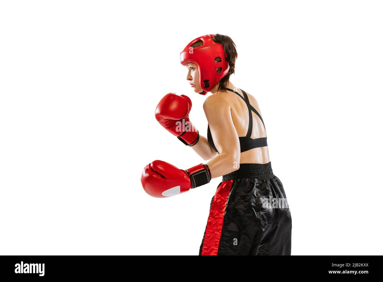 Professional female boxer in boxing gloves and helmet training isolated ...