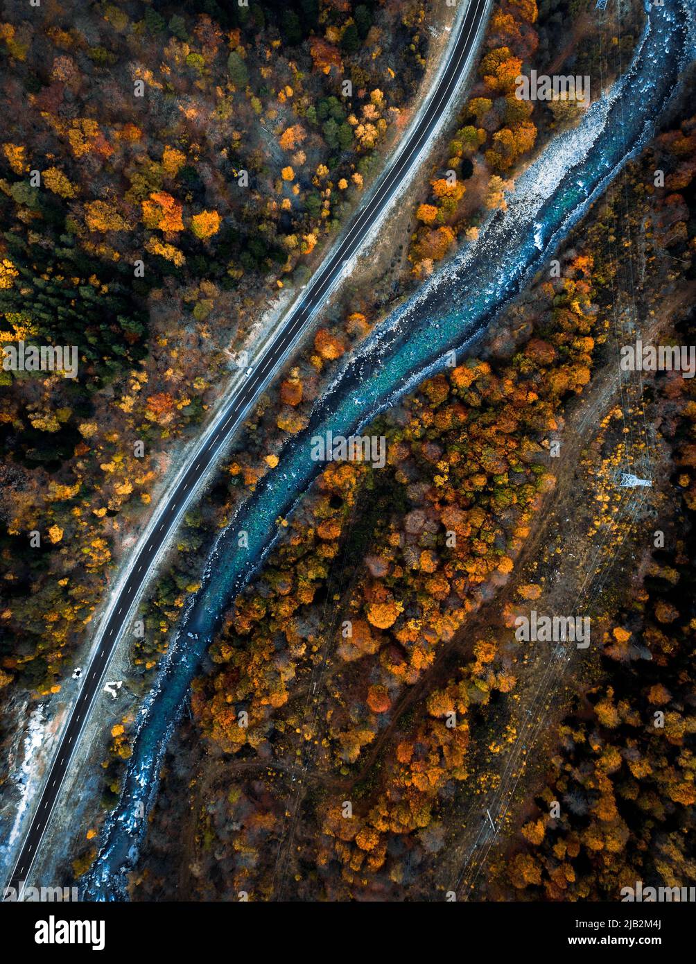 Parallel river and road in autumn forest view from drone Stock Photo ...