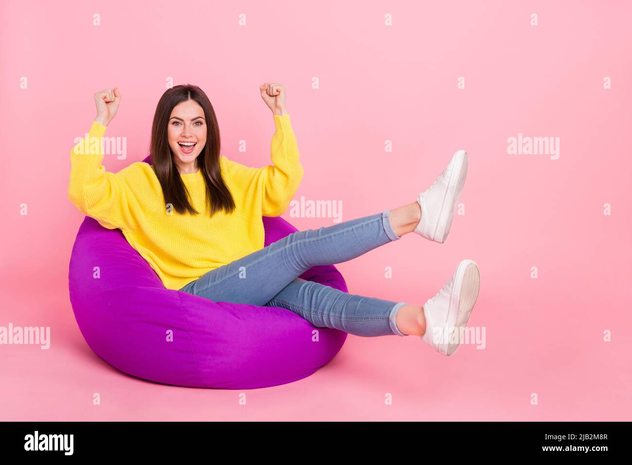 Full body photo of young excited girl sit violet chair fists hands ...