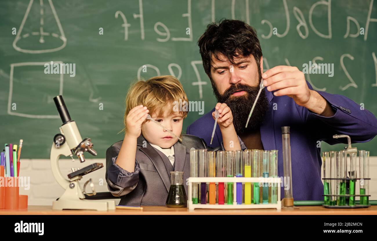 Genius kid. Teacher child test tubes. Chemical experiment. Achieving ...