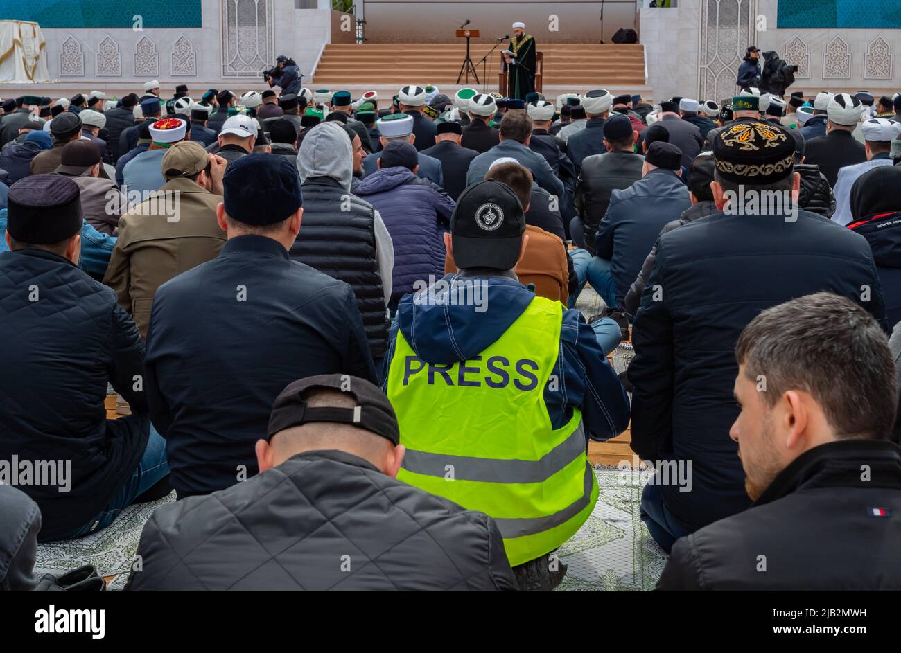 Kazan, Russia. May 20, 2022. A man in a PRESS vest among praying ...