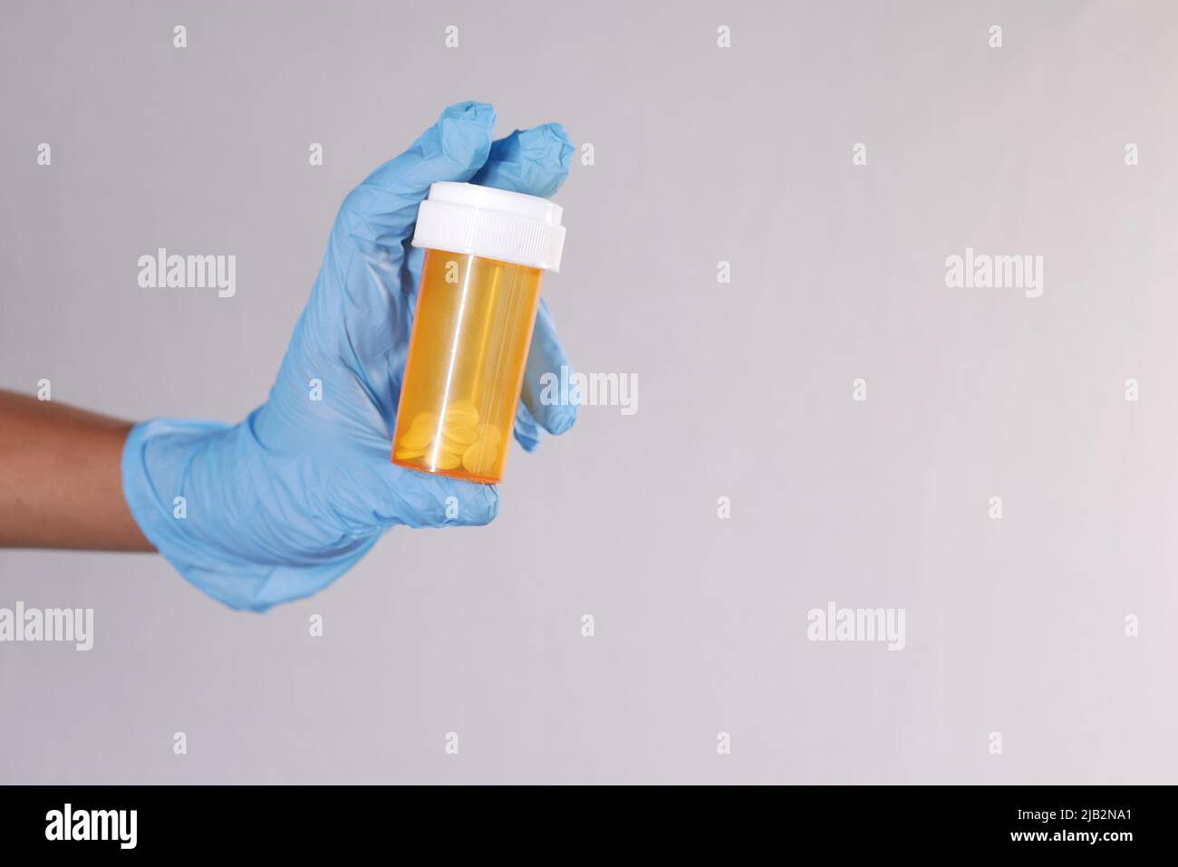 doctor hand holding pill container with copy space Stock Photo - Alamy
