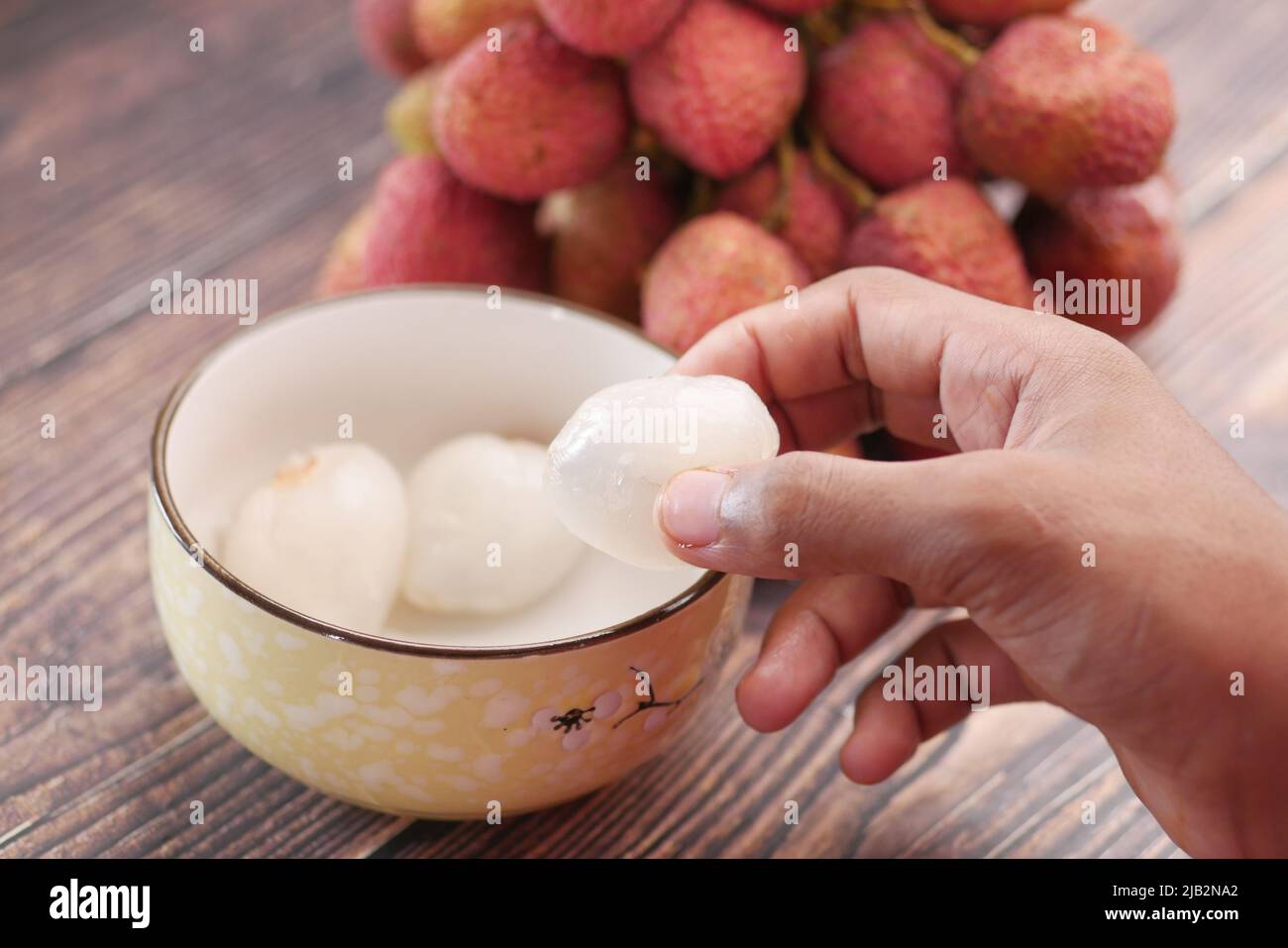 taking skin off from a Lychee fruit Stock Photo - Alamy
