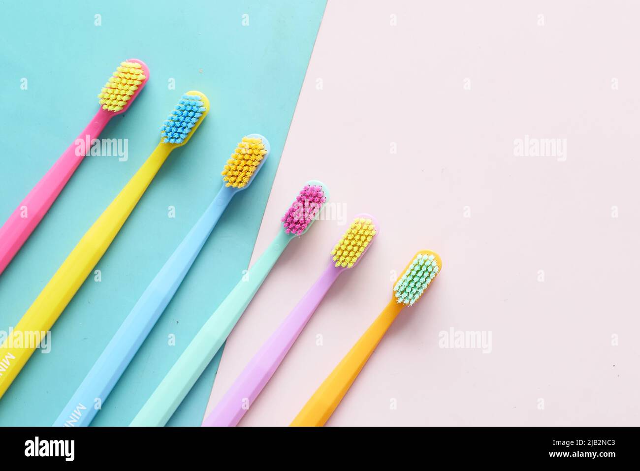 colorful toothbrushes on a color background top view Stock Photo - Alamy