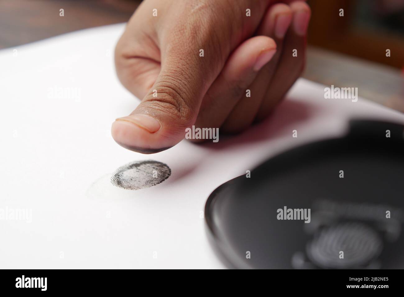 person hand putting black fingerprints on a paper close up Stock Photo ...