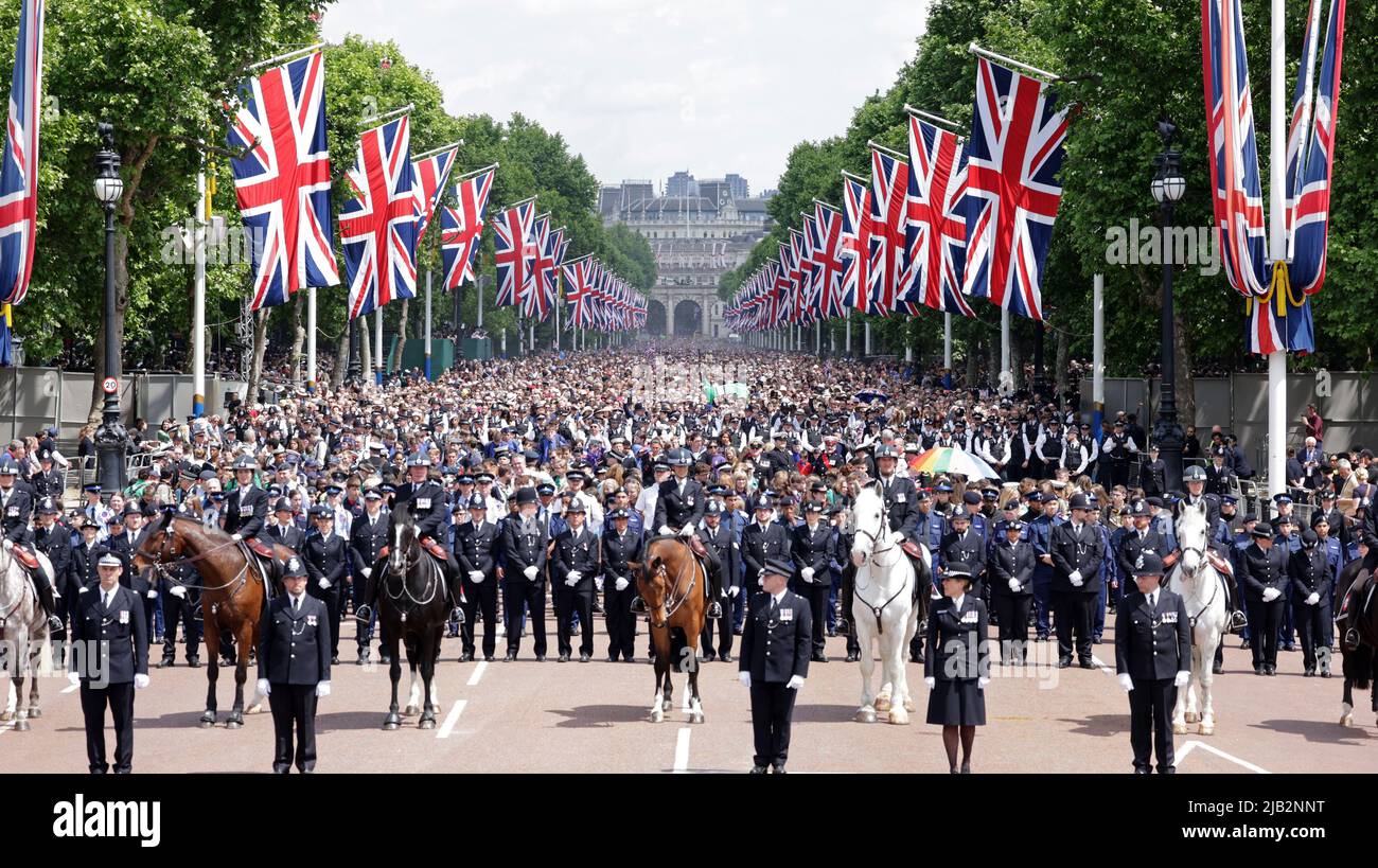 A police line walks members of the public up The Mall towards ...