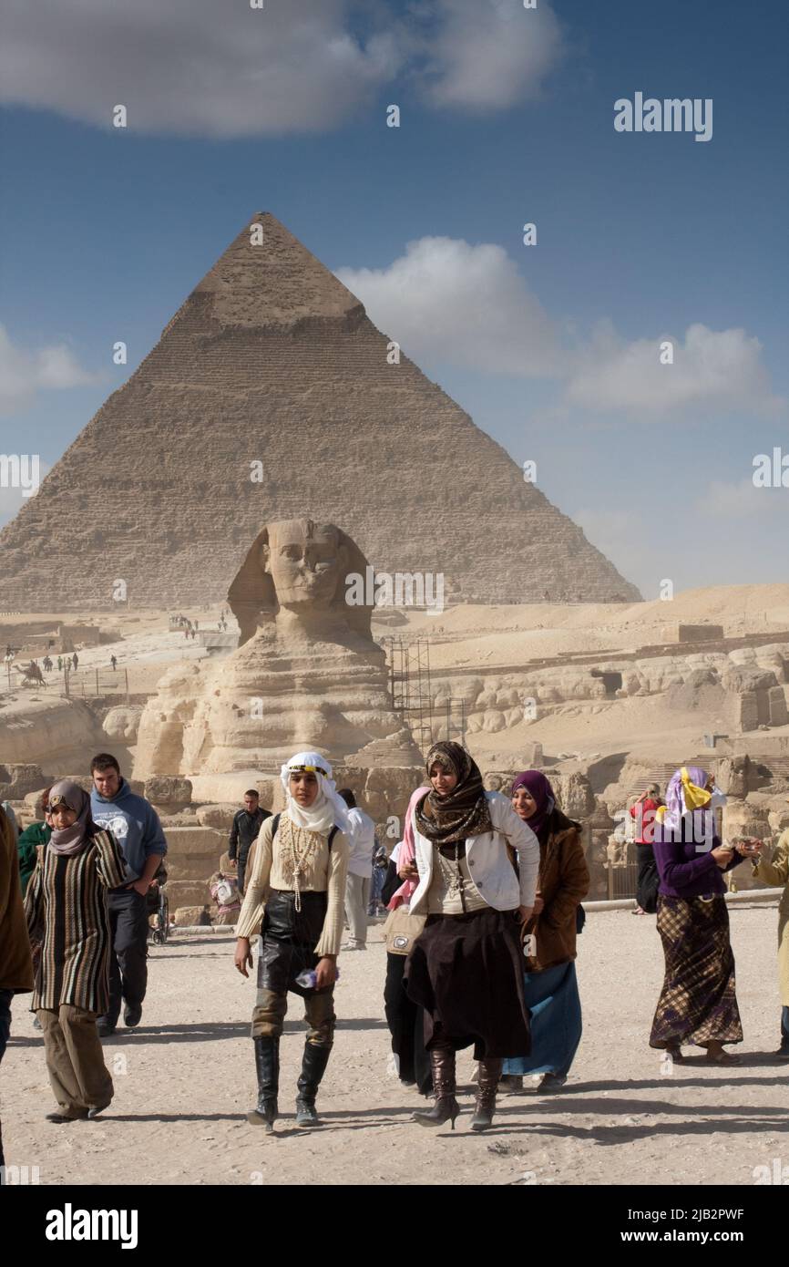 Egypt, Cairo.Local tourists in front of the spynx at the Giza pyramids ...