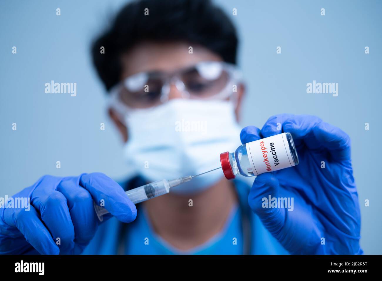 close up shot of doctor with Monkey pox vaccine using with syringe at ...