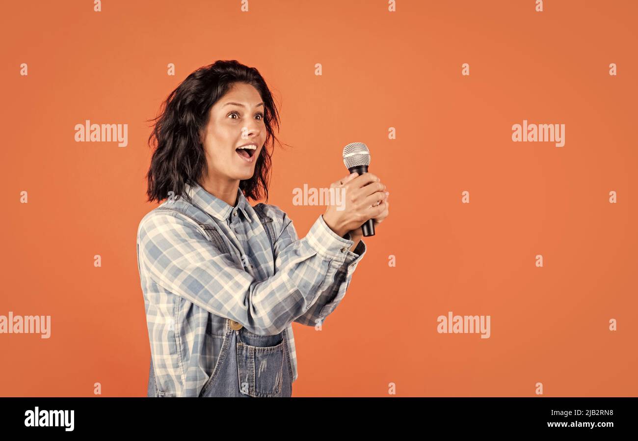 singing a song with a microphone. having a party. Happy woman with ...