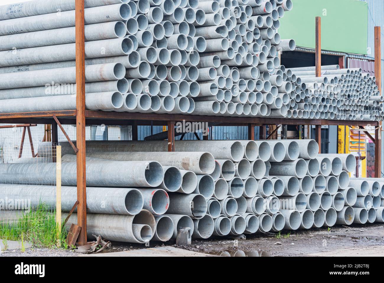 Pile of concrete pipes by the construction market shop Stock Photo - Alamy