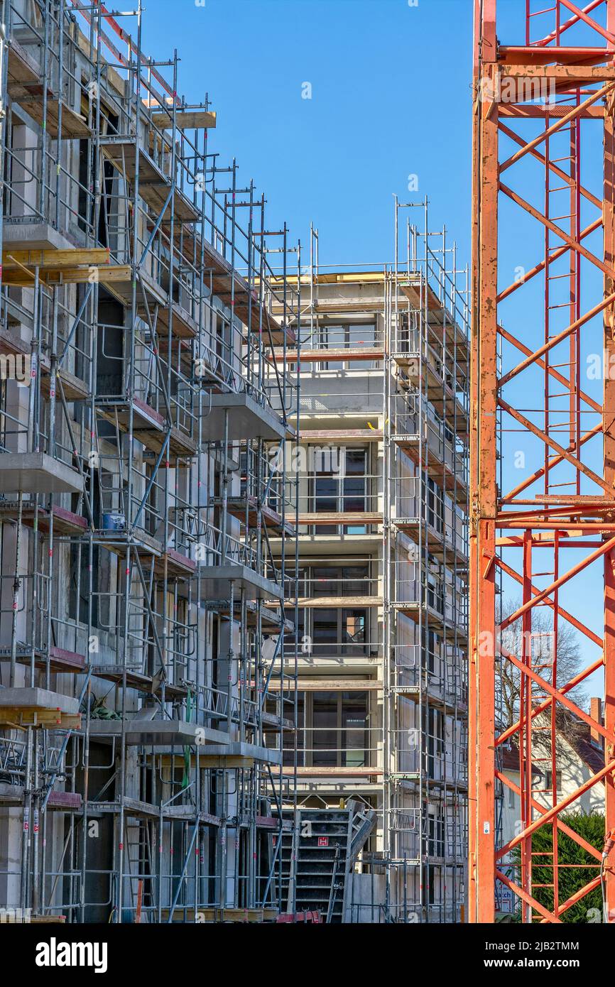 Shell construction of an apartment building with scaffolding and crane ...