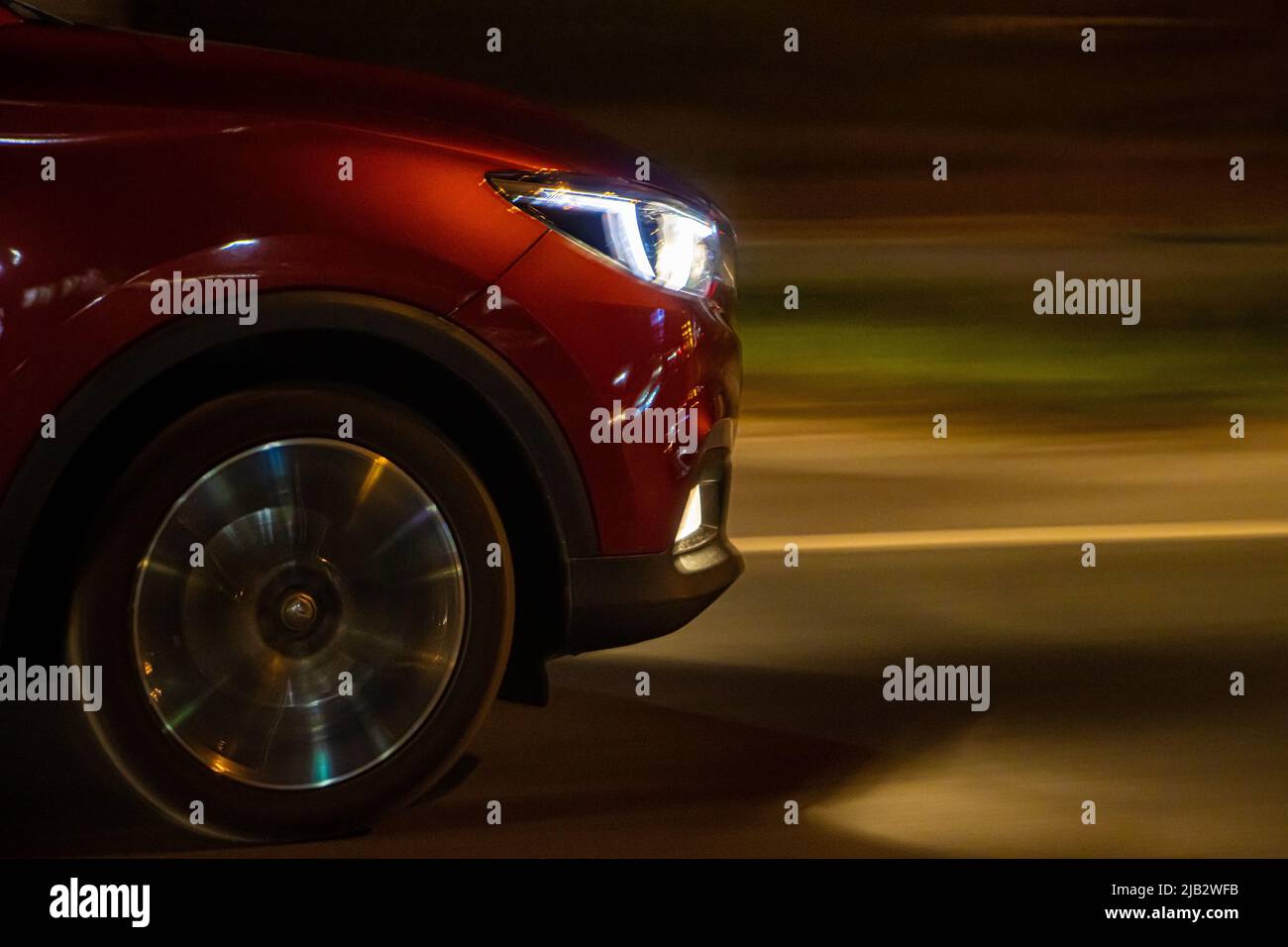 A front part with headlights of a car driving in the night on the road ...