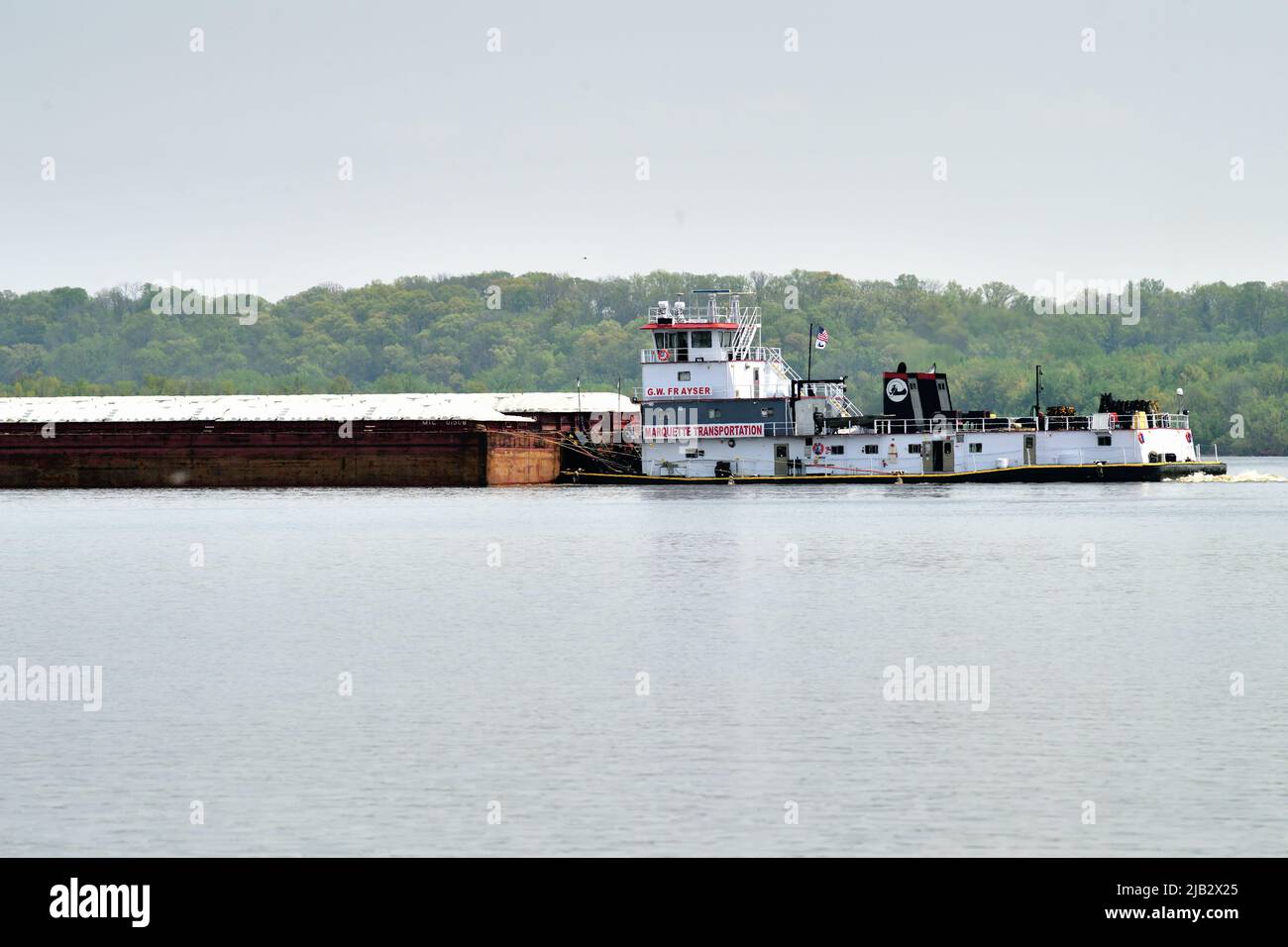 Fort Madison, Iowa, USA. Tugboat pushing multiple lashed together ...