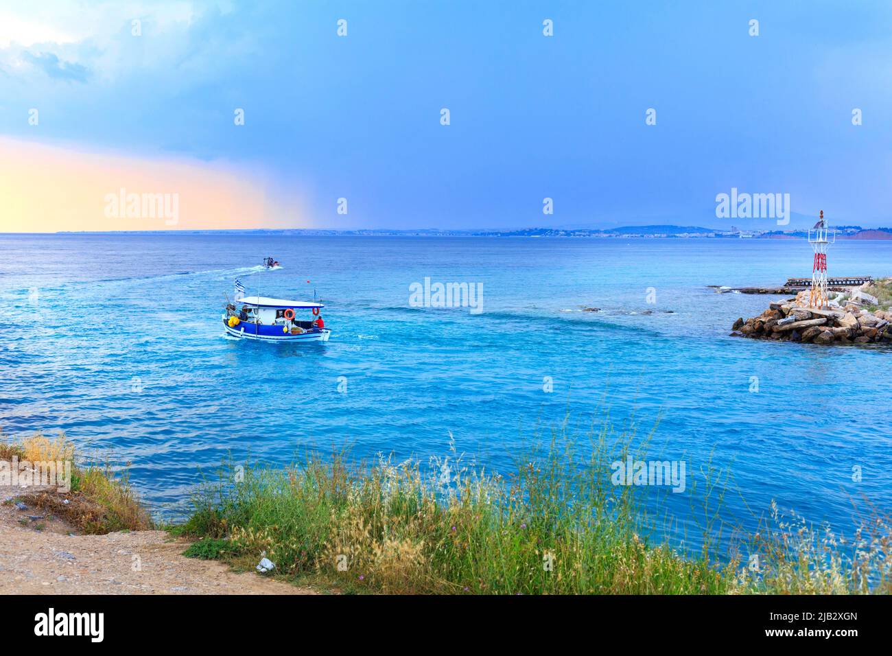 Nea Potidea, Greece - June 10, 2018: Sea bay and pier with boat in Nea ...
