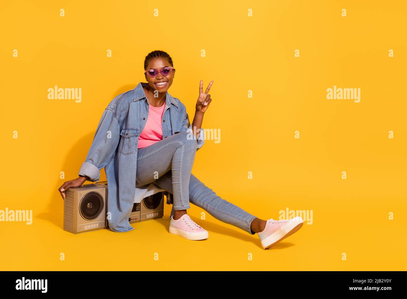 Full size photo of positive cheerful girl sit boom box hand fingers ...