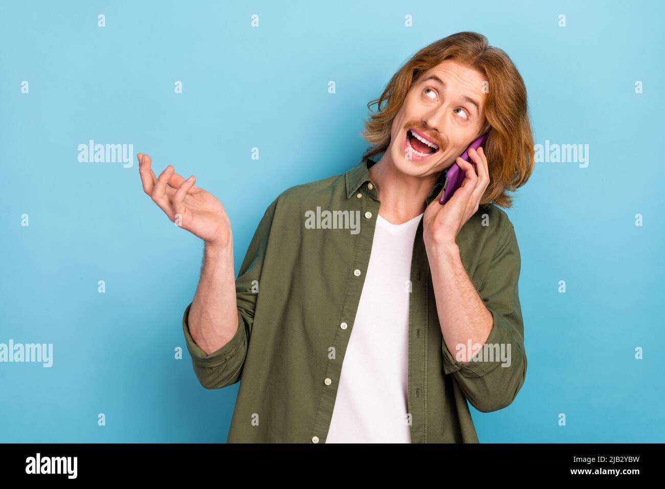 Portrait of attractive funky cheerful guy talking on phone discussing ...
