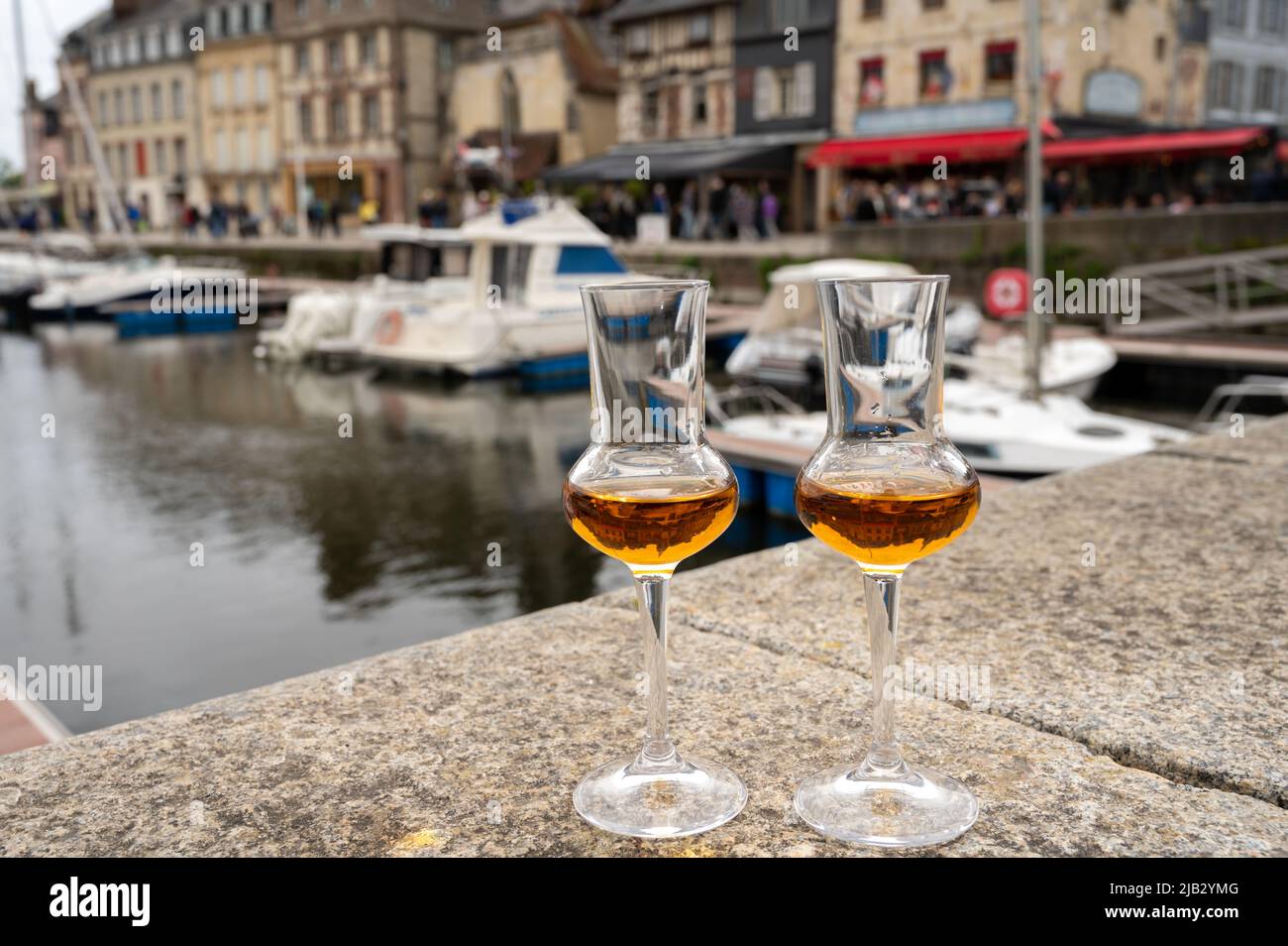 Tasting of apple calvados drink from glasses in old Honfleur harbour ...