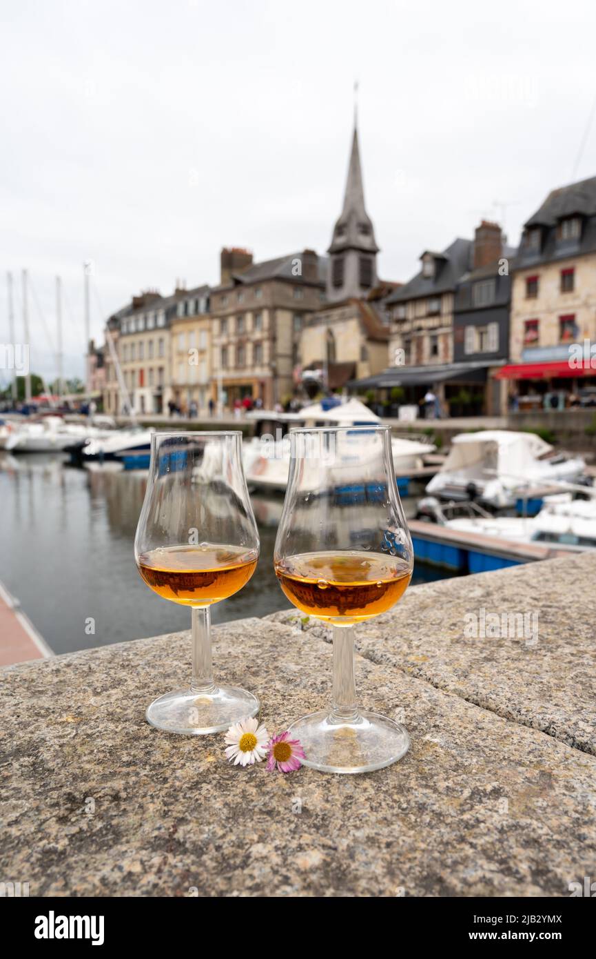 Tasting of apple calvados drink from glasses in old Honfleur harbour ...
