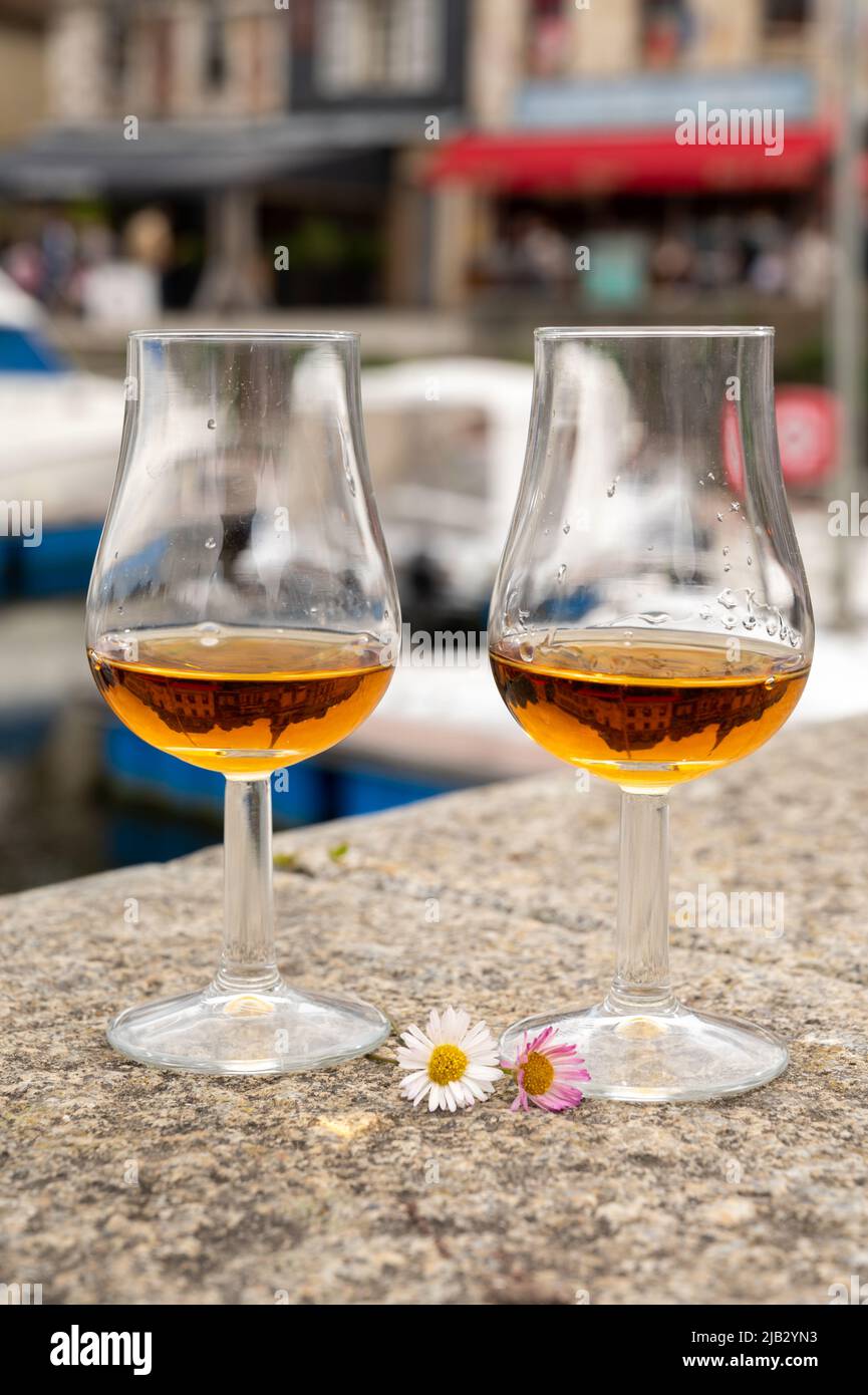 Tasting of apple calvados drink from glasses in old Honfleur harbour ...