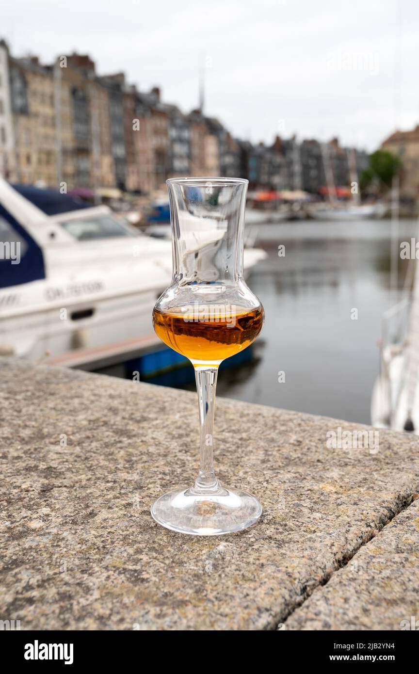 Tasting of apple calvados drink from glasses in old Honfleur harbour ...