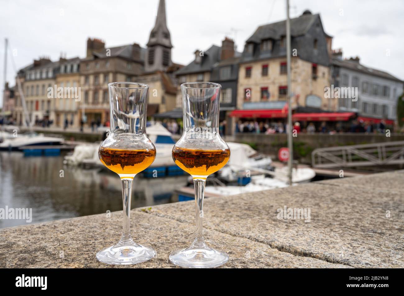 Tasting of apple calvados drink from glasses in old Honfleur harbour ...