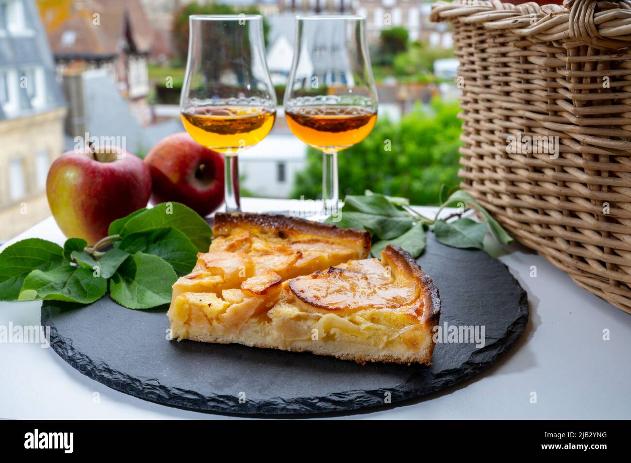 Tasting of fresh baked apple cake and strong alcoholic drink calvados ...