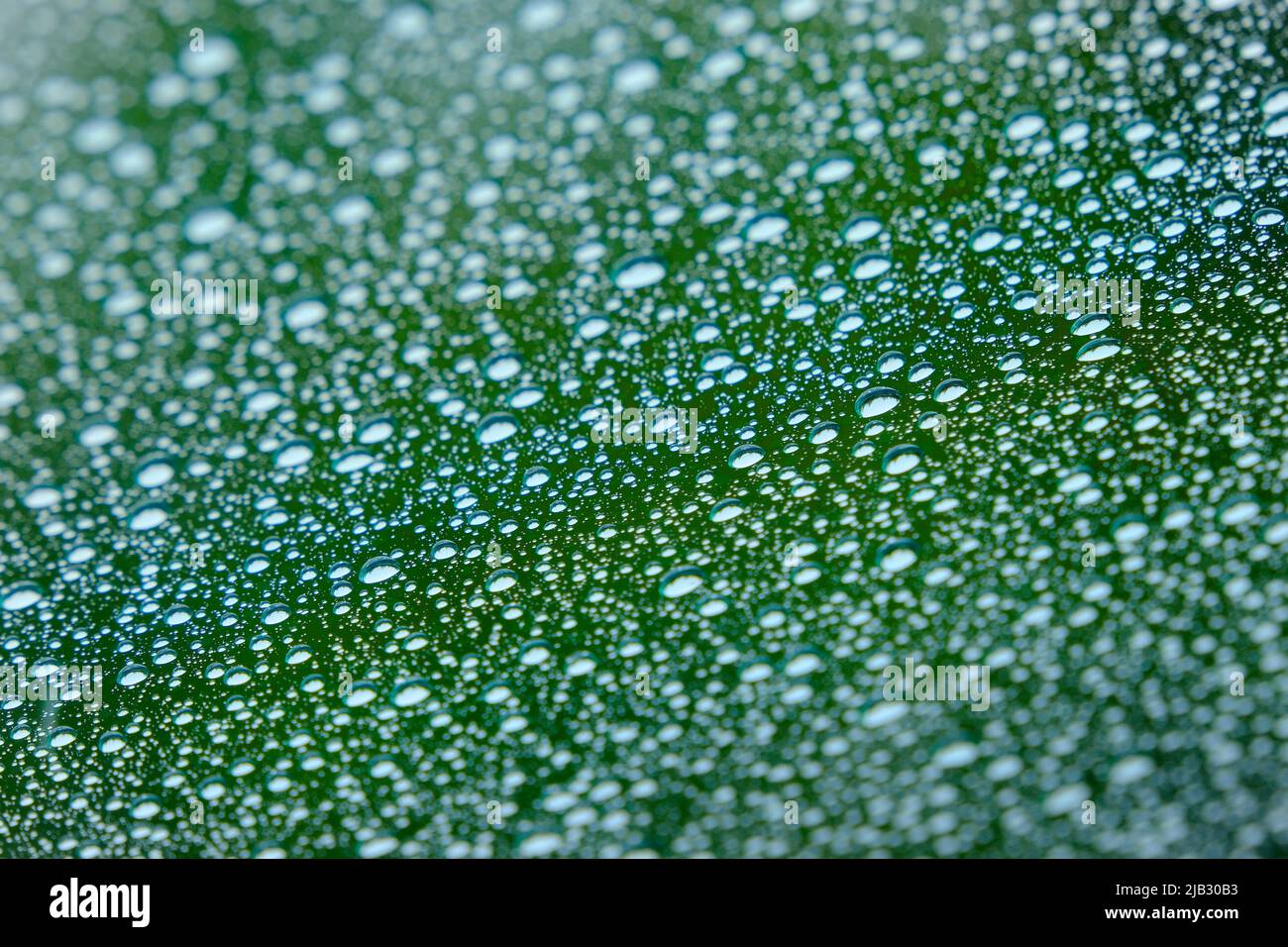 Water drops collecting from rain on window of car stormy weather Stock ...