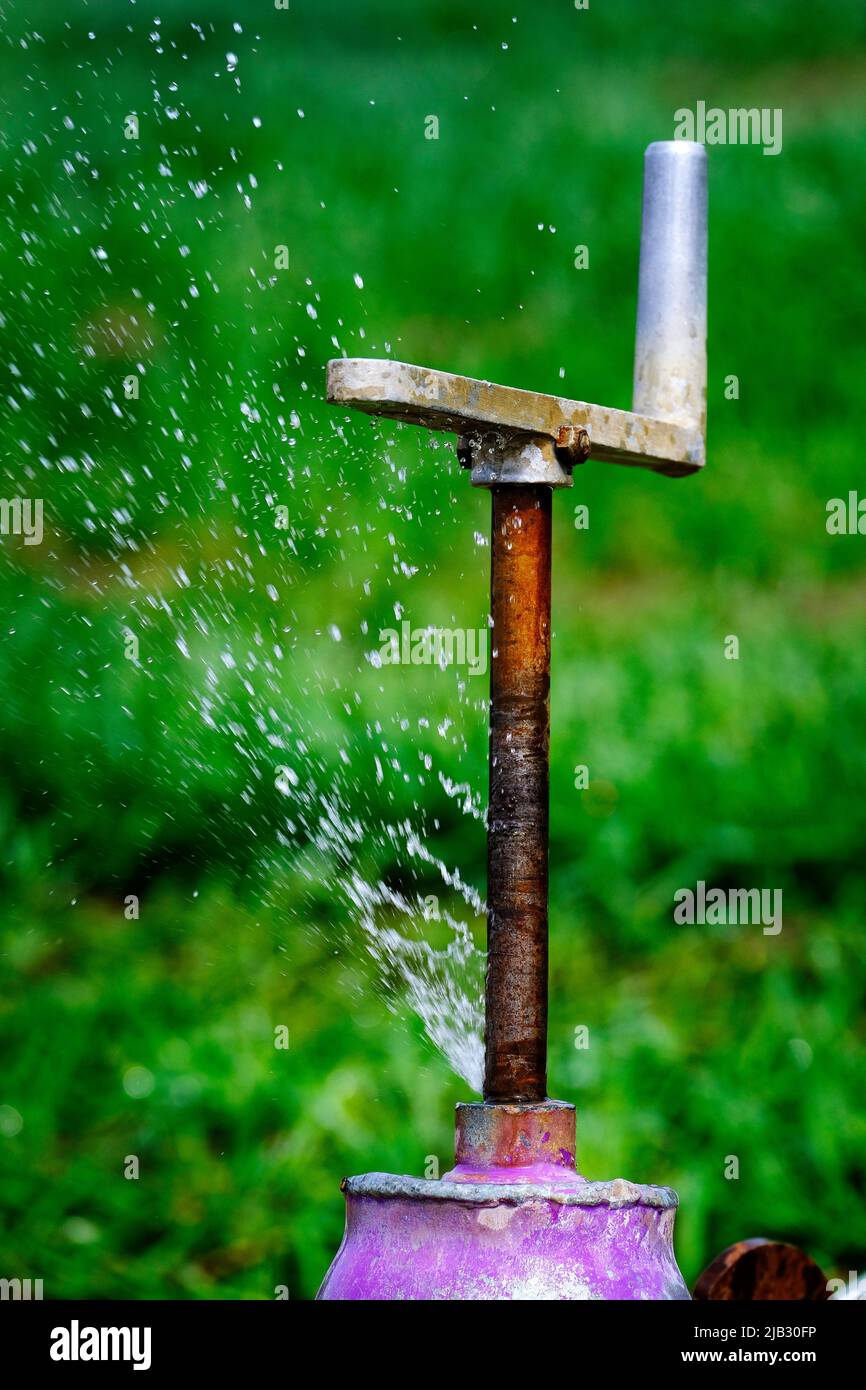 Sprinkler pipe with leaky valve and water leaking and spraying from ...