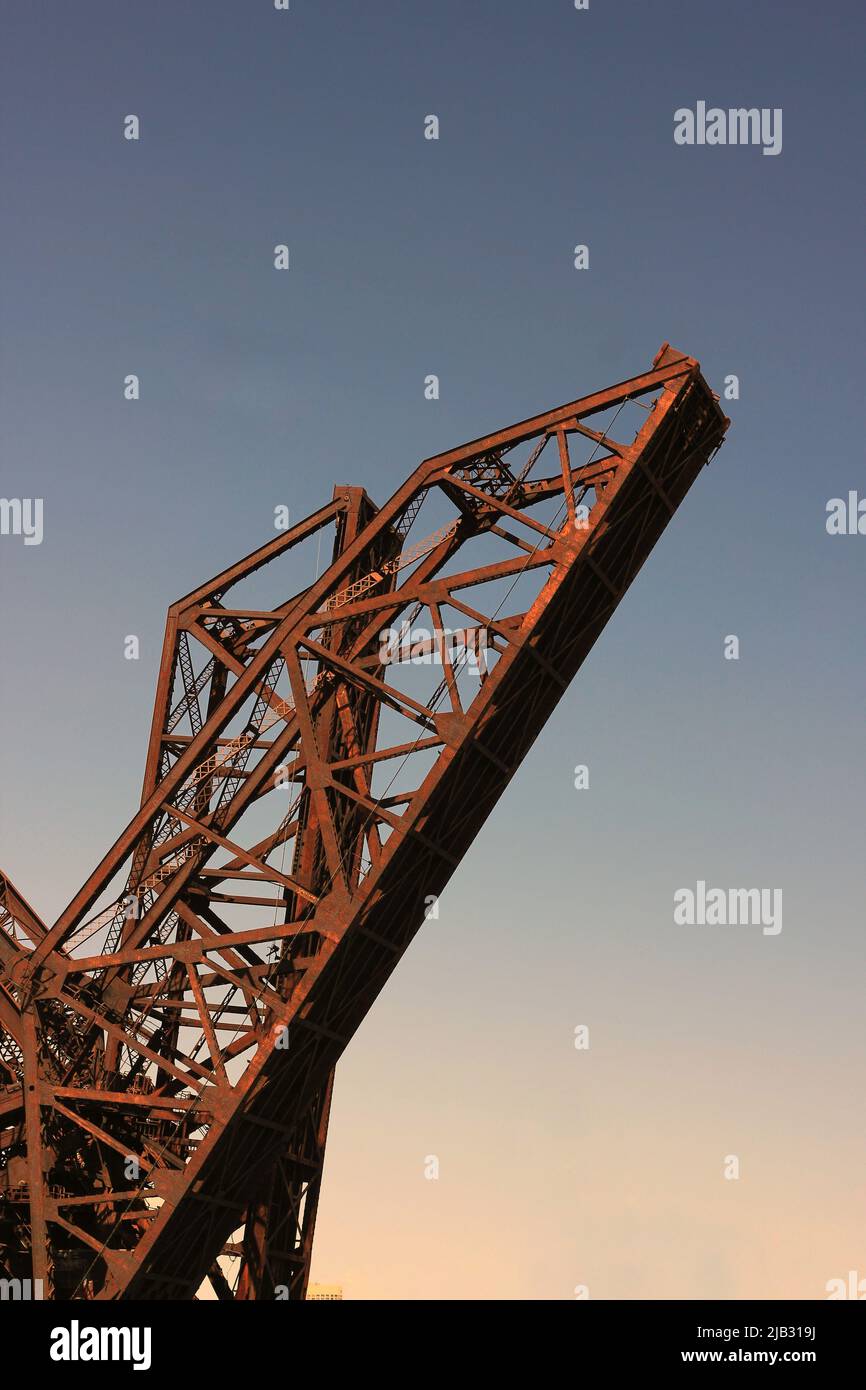 A very tall steel truss structure standing in the industrial district ...