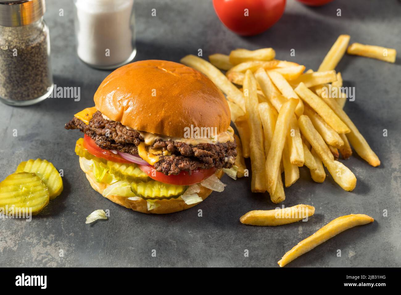 Homemade Cheese Smash Burger with Fries Pickles and Tomatoes Stock ...