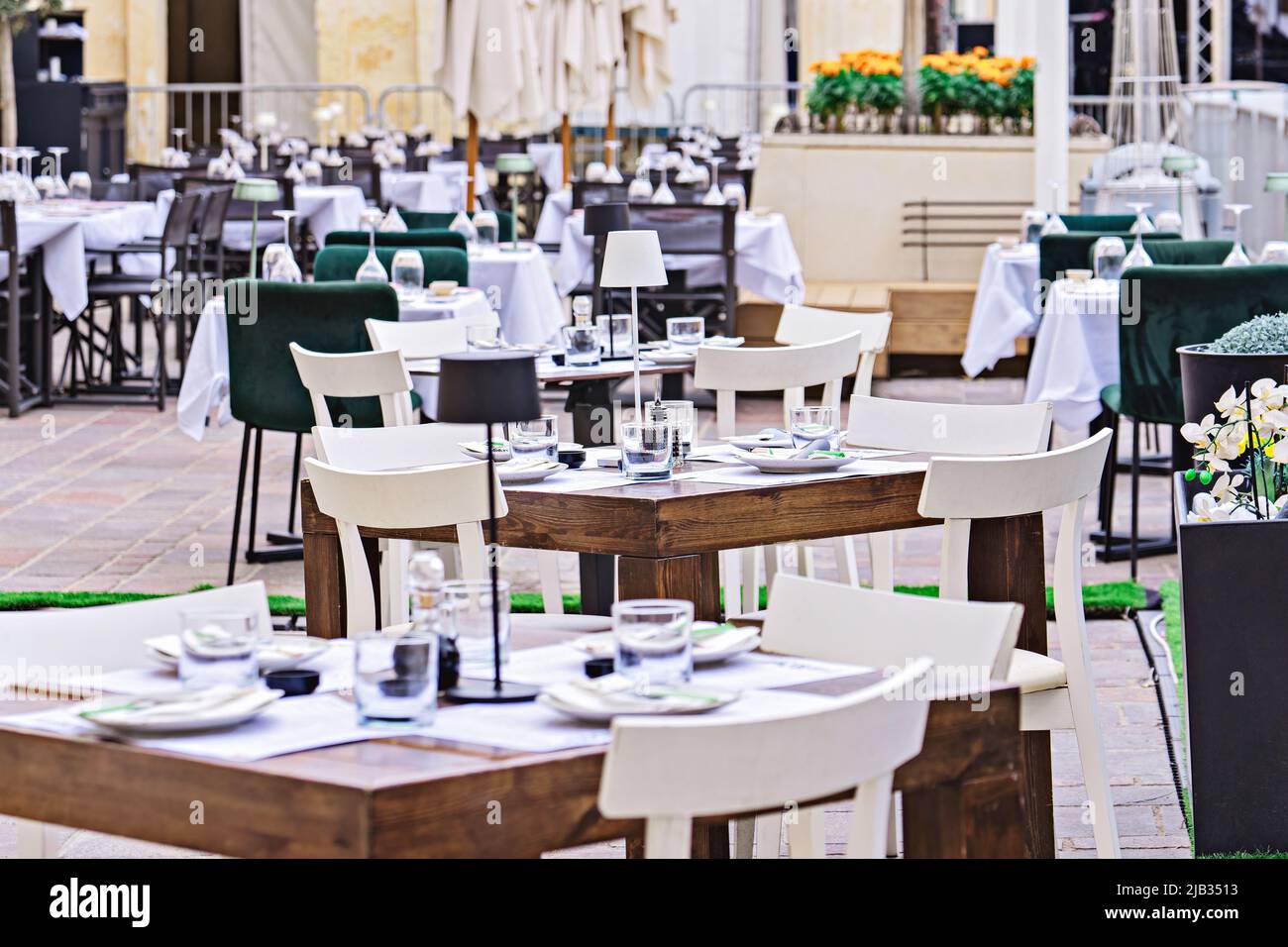General view of served tables in an open-air restaurant, ready to ...