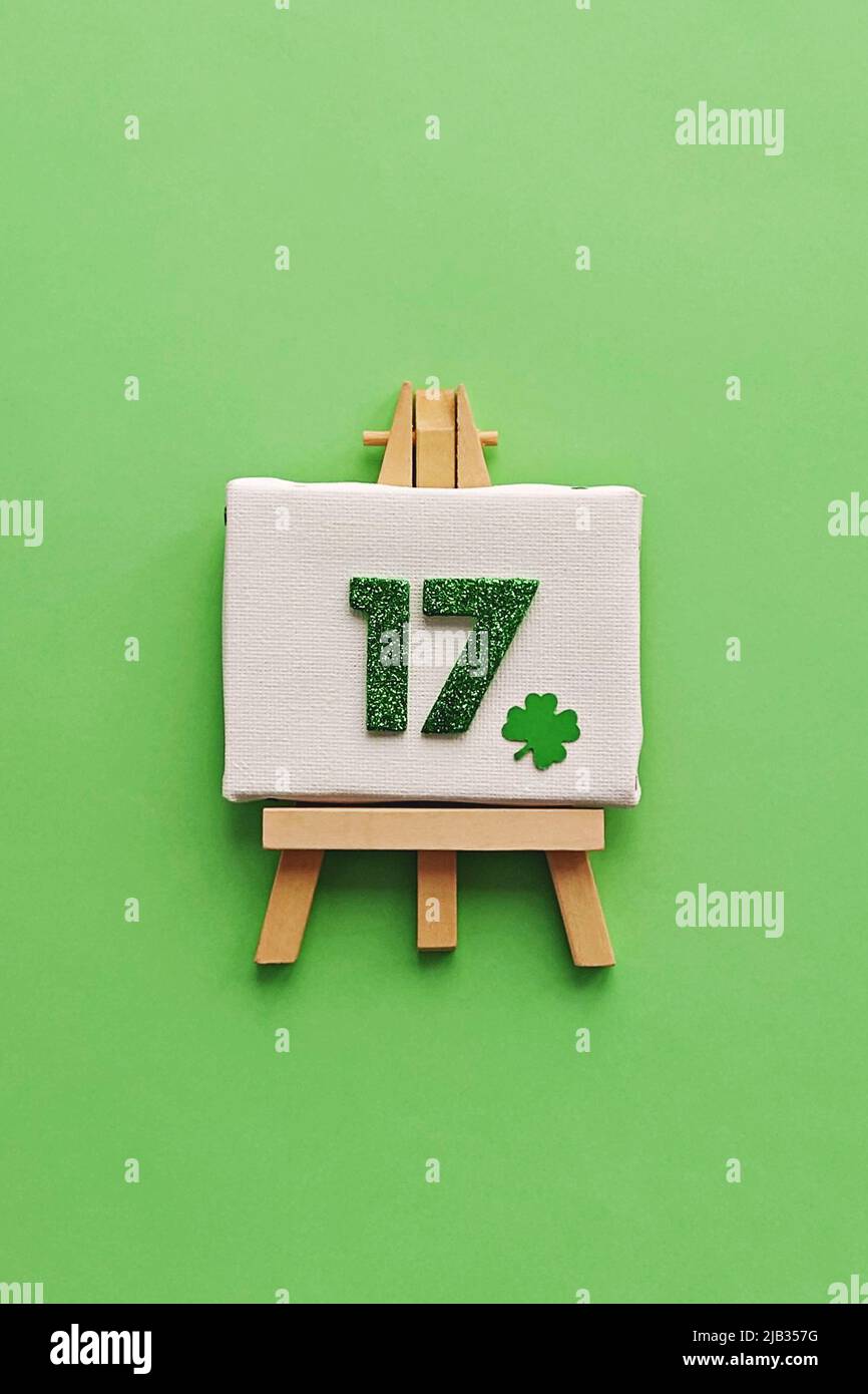 Miniature easel with canvas and green numbers 17 with four-leaf clover ...