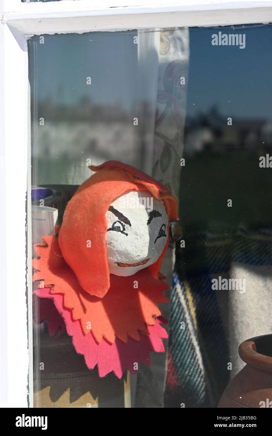 scary model with painted face in window, england Stock Photo - Alamy