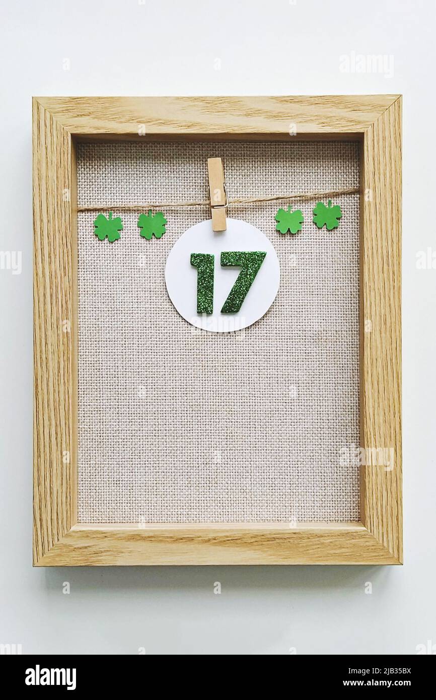 Wooden frame with miniature green numbers 17 with four-leaf clover on ...