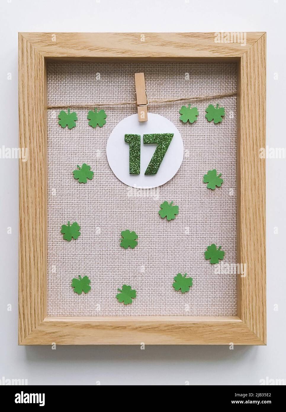 Wooden frame with miniature green numbers 17 with four-leaf clover on ...