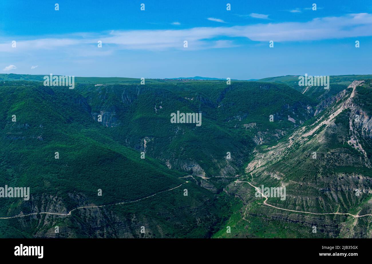 winding road along a wooded mountain slope in a highland area Stock ...