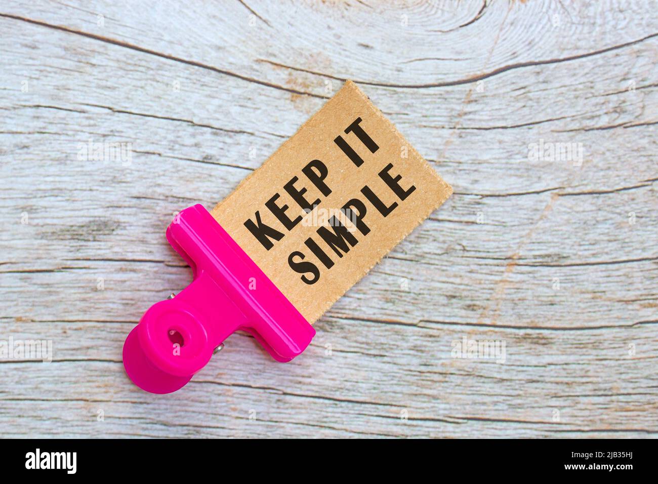 Keep it simple town brown paper with paper clip on wooden table ...