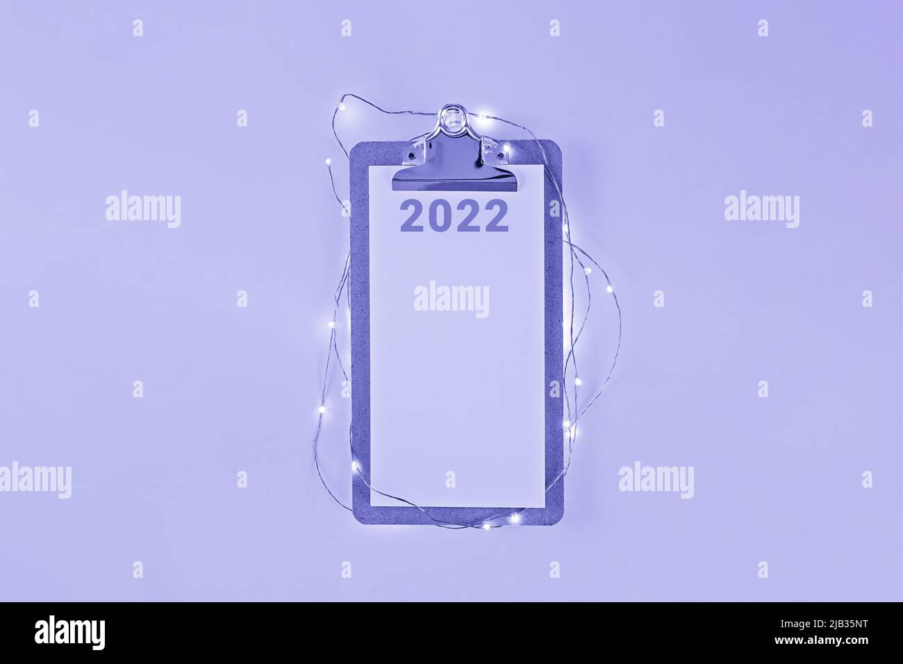 2022 on clipboard page with led-lights on very peri background Stock ...