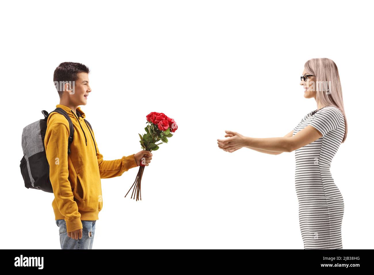 Schoolboy giving a bunch of red roses to a woman isolated on white ...
