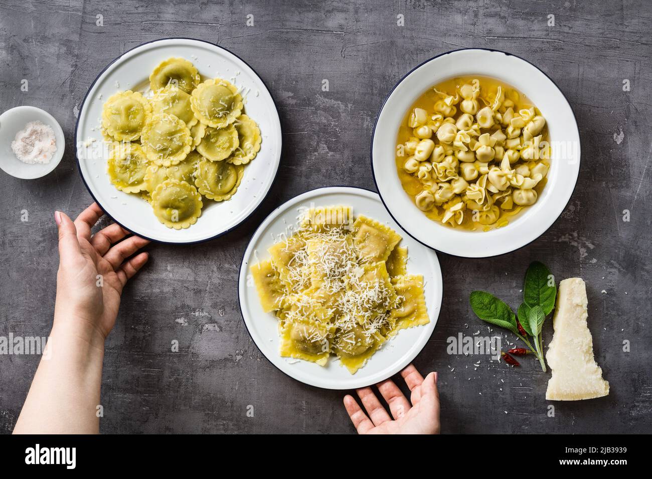 several types of boiled italian ravioli in plates on the table ...