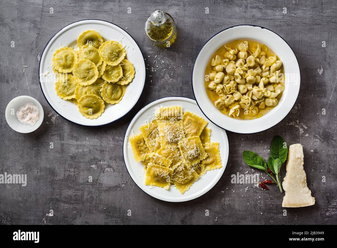 several types of boiled italian ravioli in plates on the table ...
