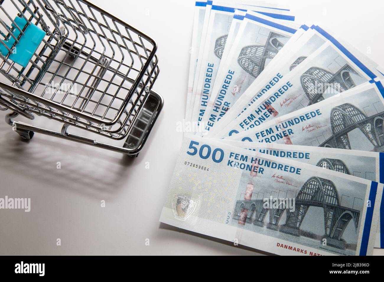 Money of Denmark. Danish kroner bills and supermarket shopping cart ...