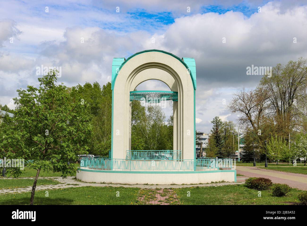 A strange building on the territory of an urban park. Arch, monument ...