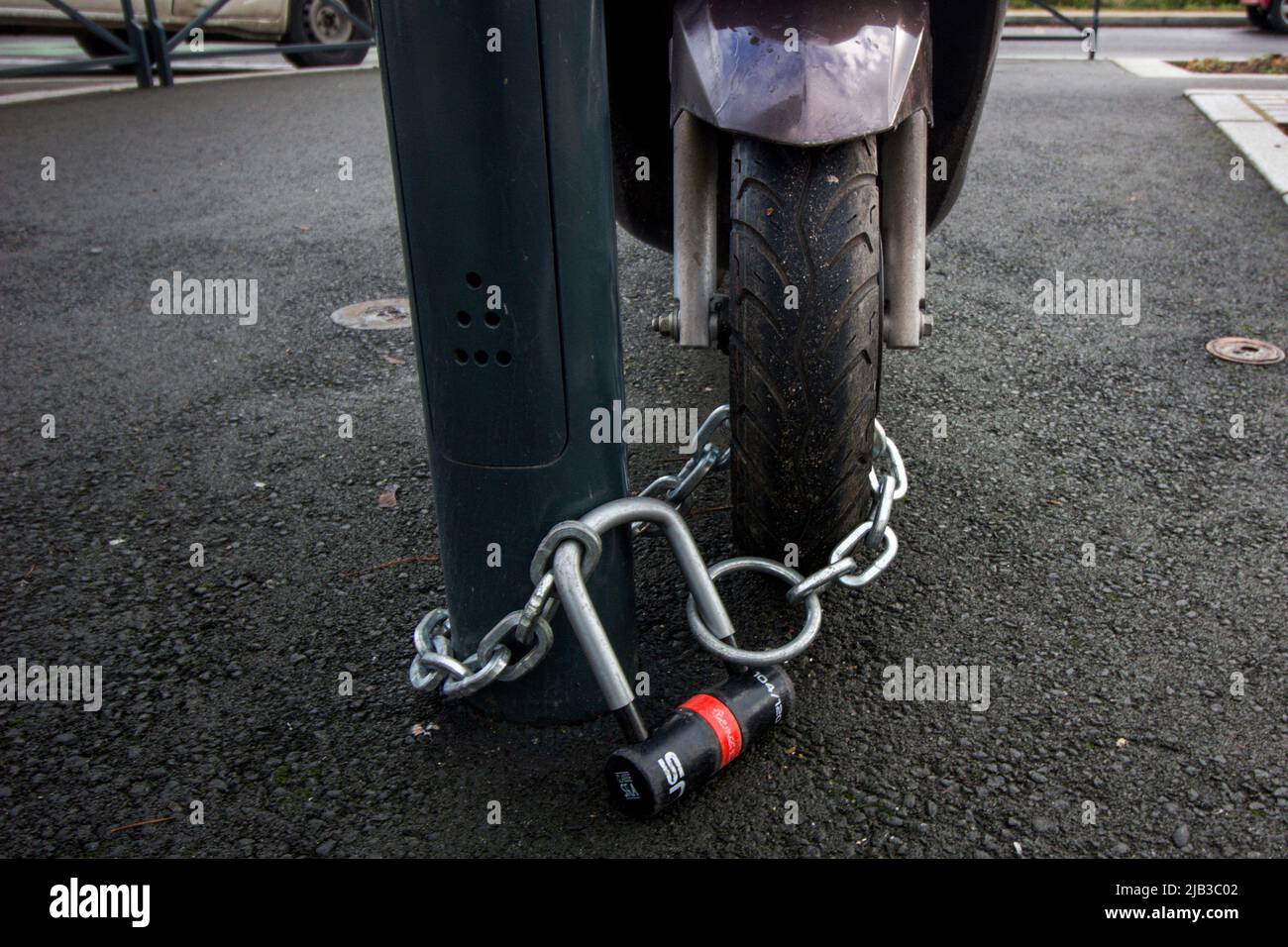 A motorbike chained for safety reasons to a post. Rennes city ...
