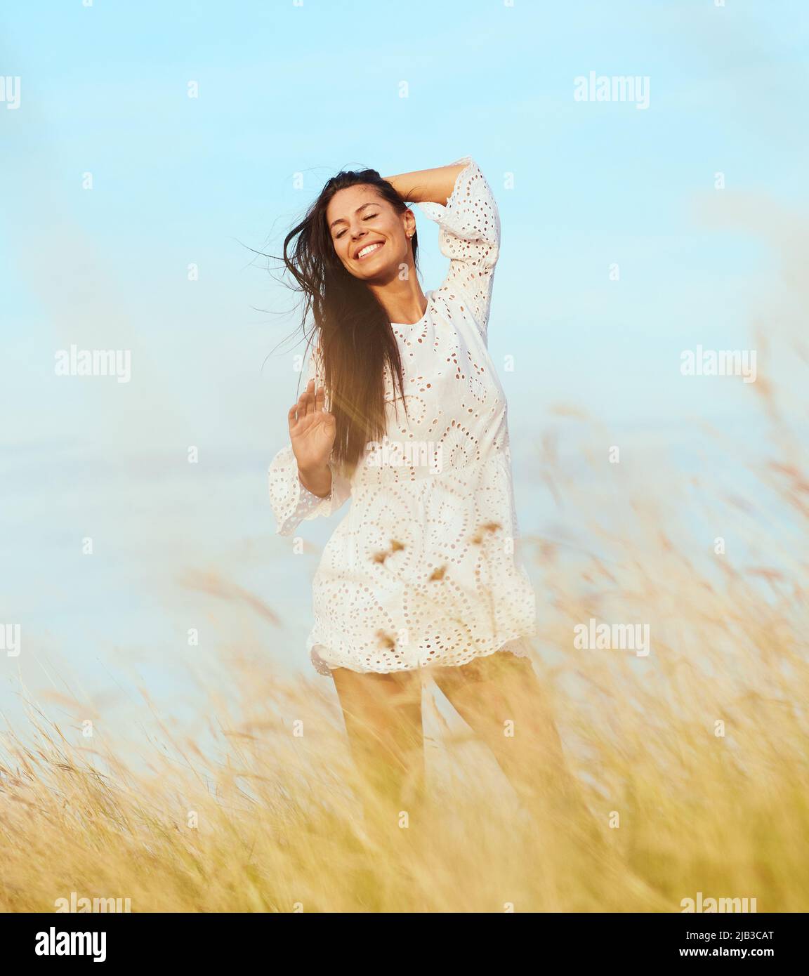 Portrait of a young beautiful girl posing outdoors in the field Stock ...