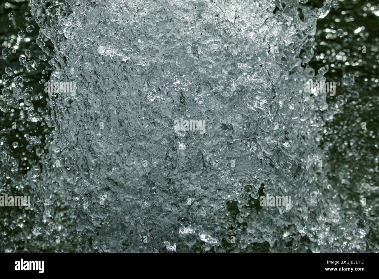 Close-up view of streams of fountain with reflection and lens flare ...