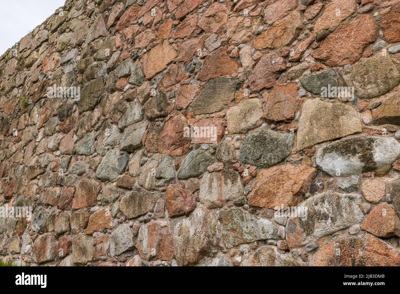 Close up view of natural nature stone wall texture on sky background ...