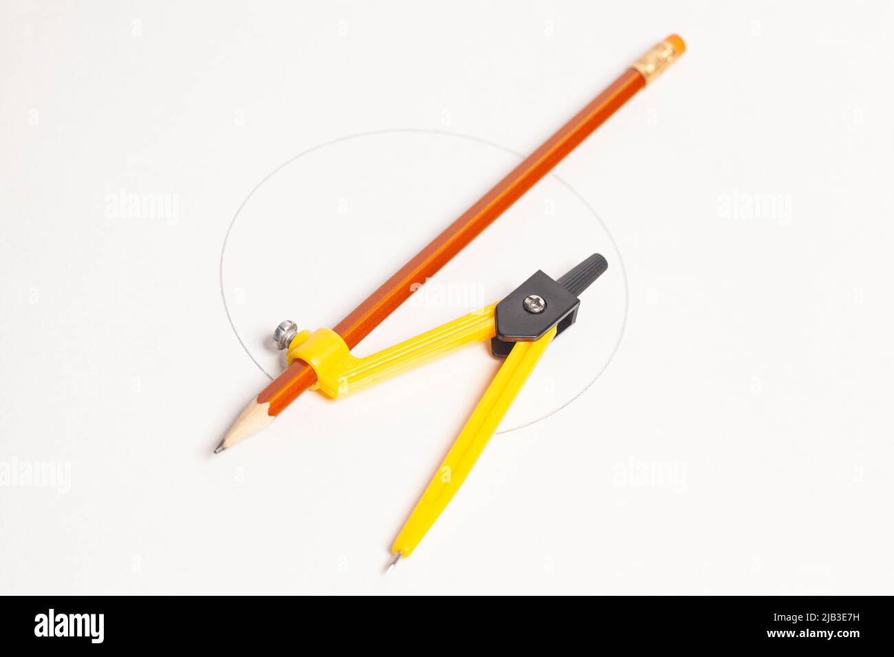 Yellow compass with pencil isolated on white background Stock Photo - Alamy