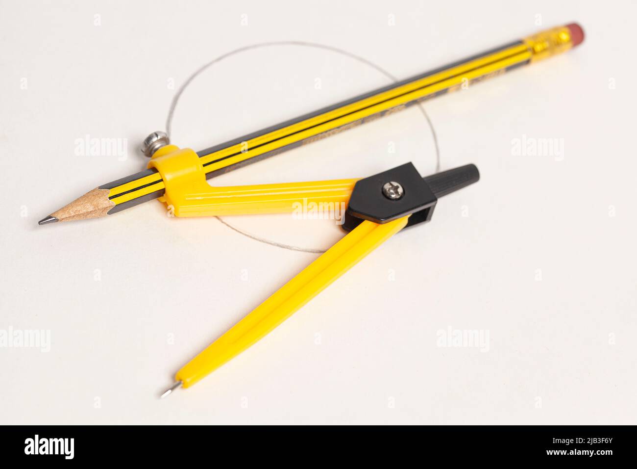Yellow compass with pencil isolated on white background Stock Photo - Alamy