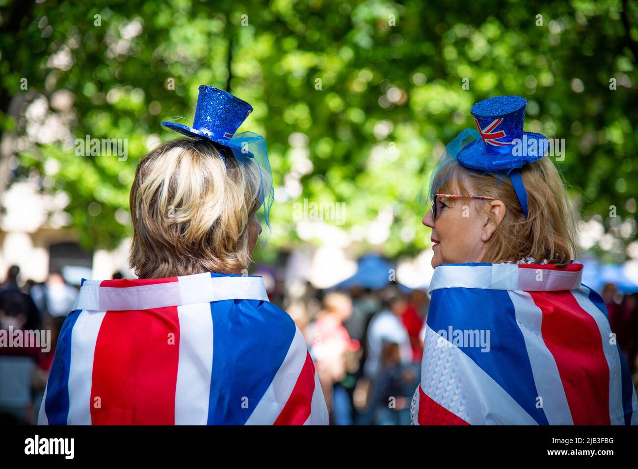 Fans are adorned in celebratory hats and flags during the Queen ...